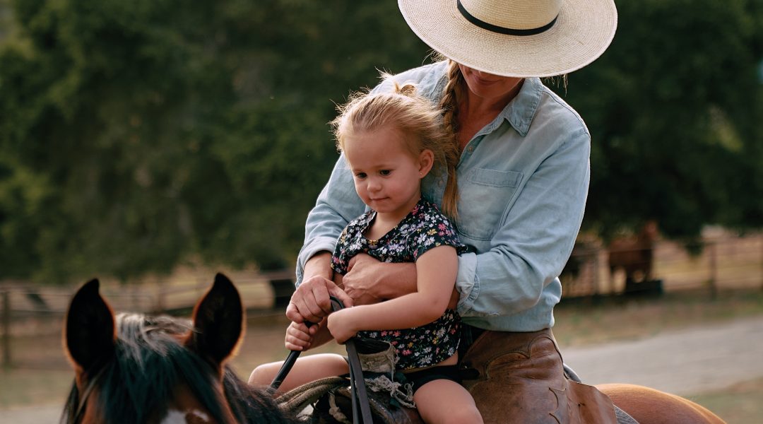 Elizabeth-Poett-with-child-on-horse - Cowboys and Indians Magazine
